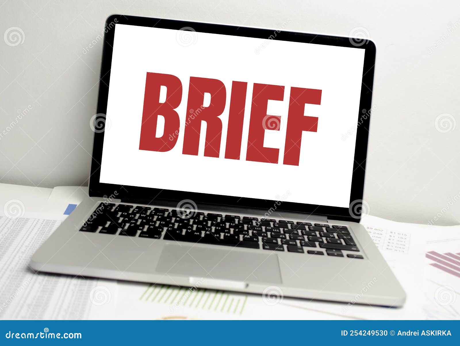 Word Brief on Laptop and Charts on White Background Stock Photo - Image ...