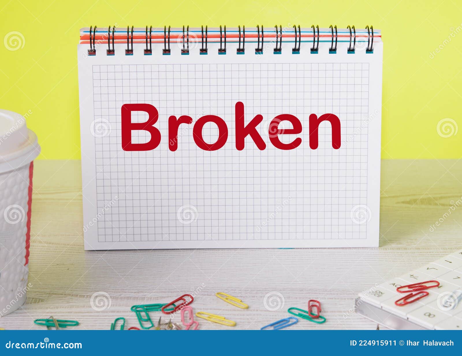 The Word is Broken on the Notebook Next To the Paper Clips, a Glass ...