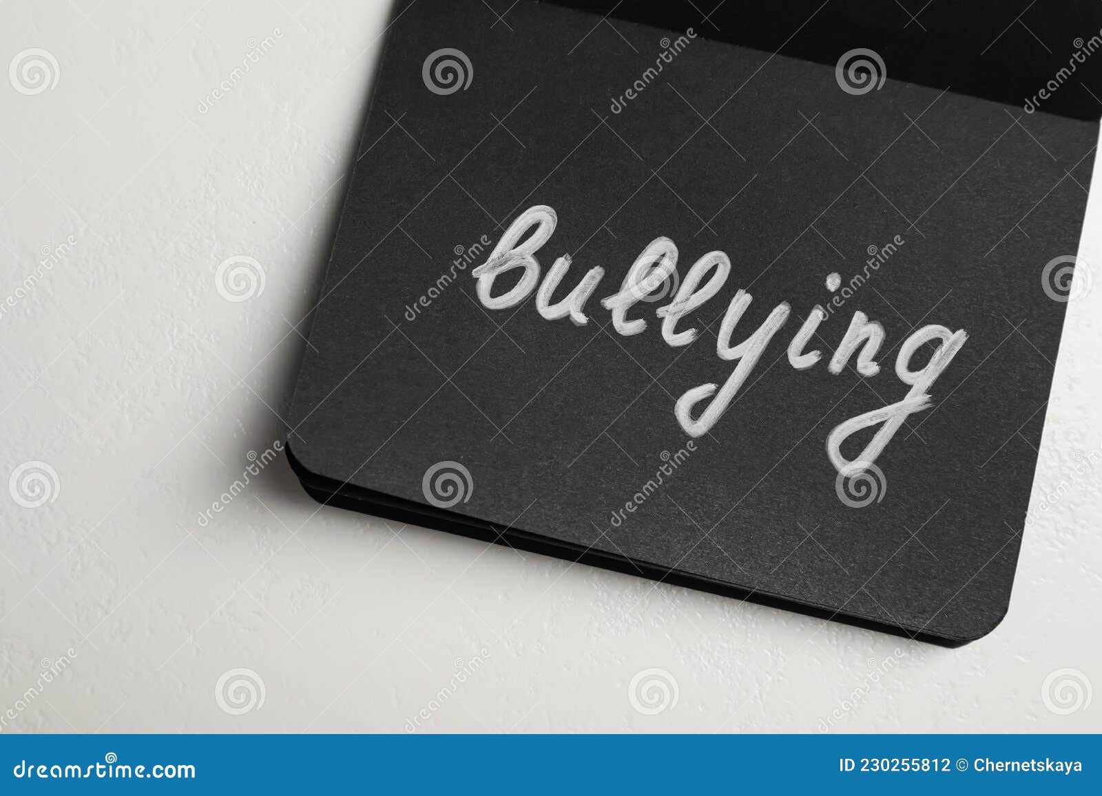Word Bullying Written in Black Notebook on White Stone Surface, Top ...