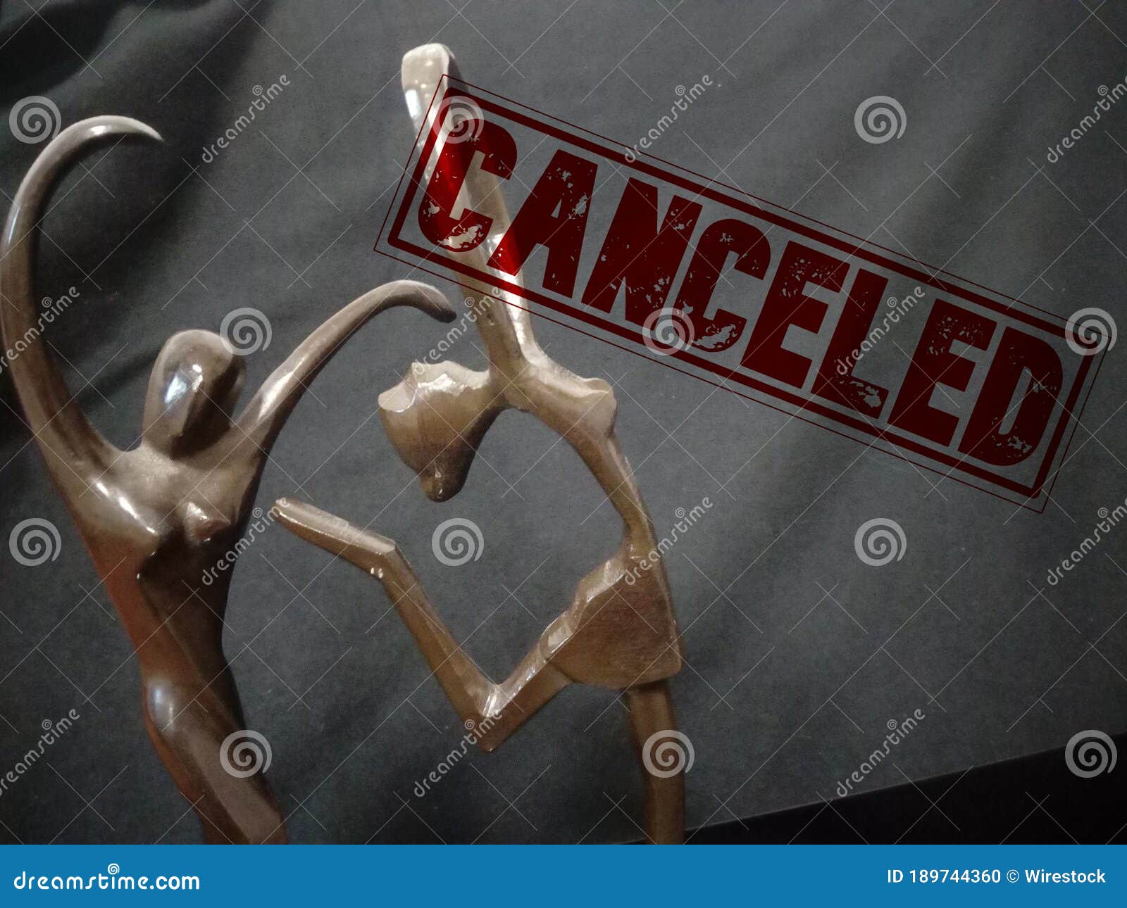 Word Canceled on the Statues of Dancing People Behind a Gray Background ...
