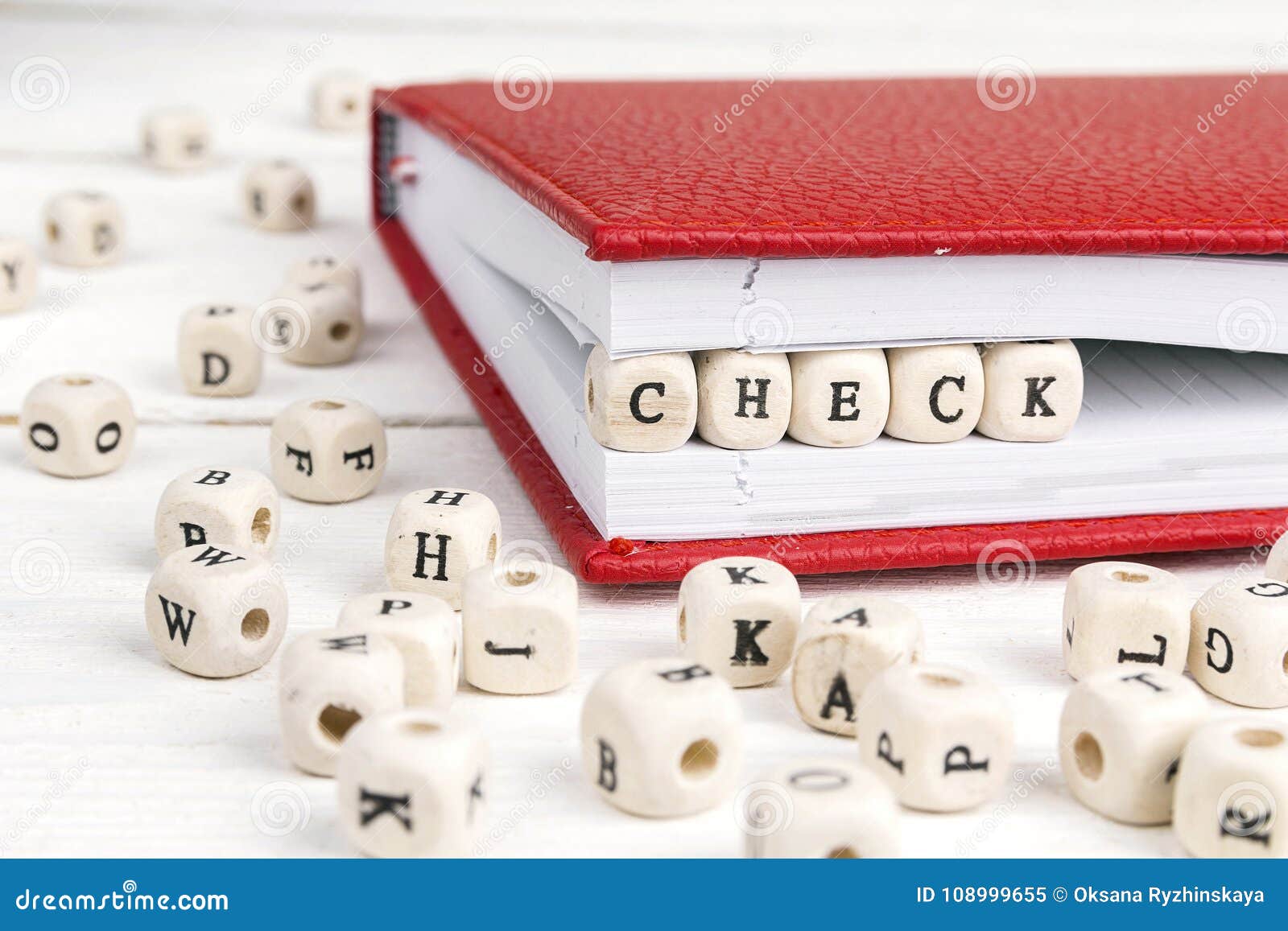 Word Check Written in Wooden Blocks in Notebook on White Wooden Stock ... Word Check Written in Wooden Blocks in Notebook on White Wooden Stock ...