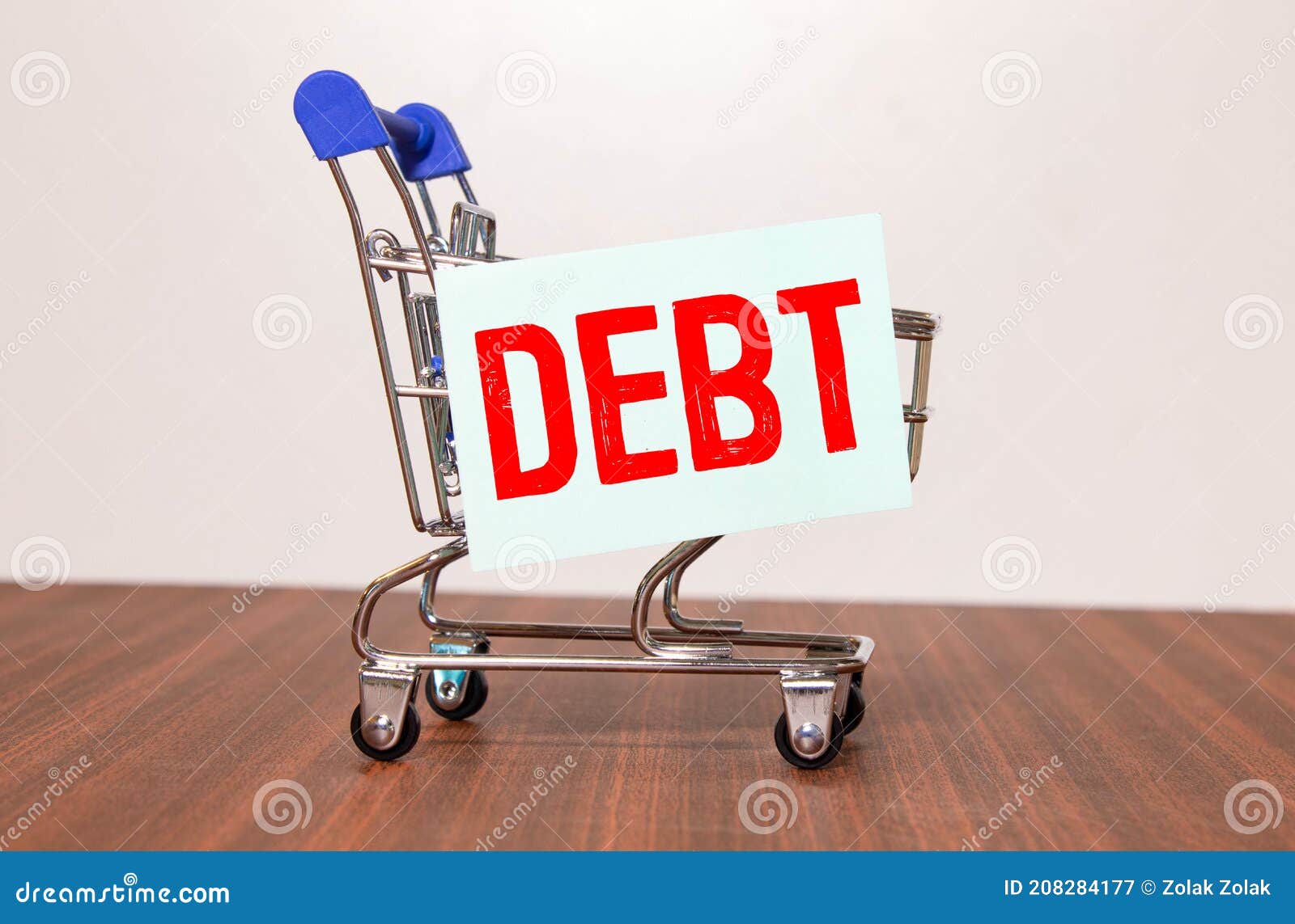 The Word DEBT is Written in Black Marker on the Yellow Paper for Notes ...