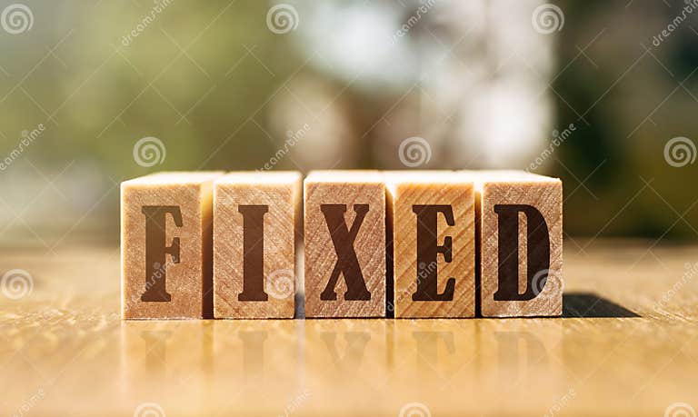 Word FIXED Made with Building Wooden Blocks on Table in Sunlight Stock ...