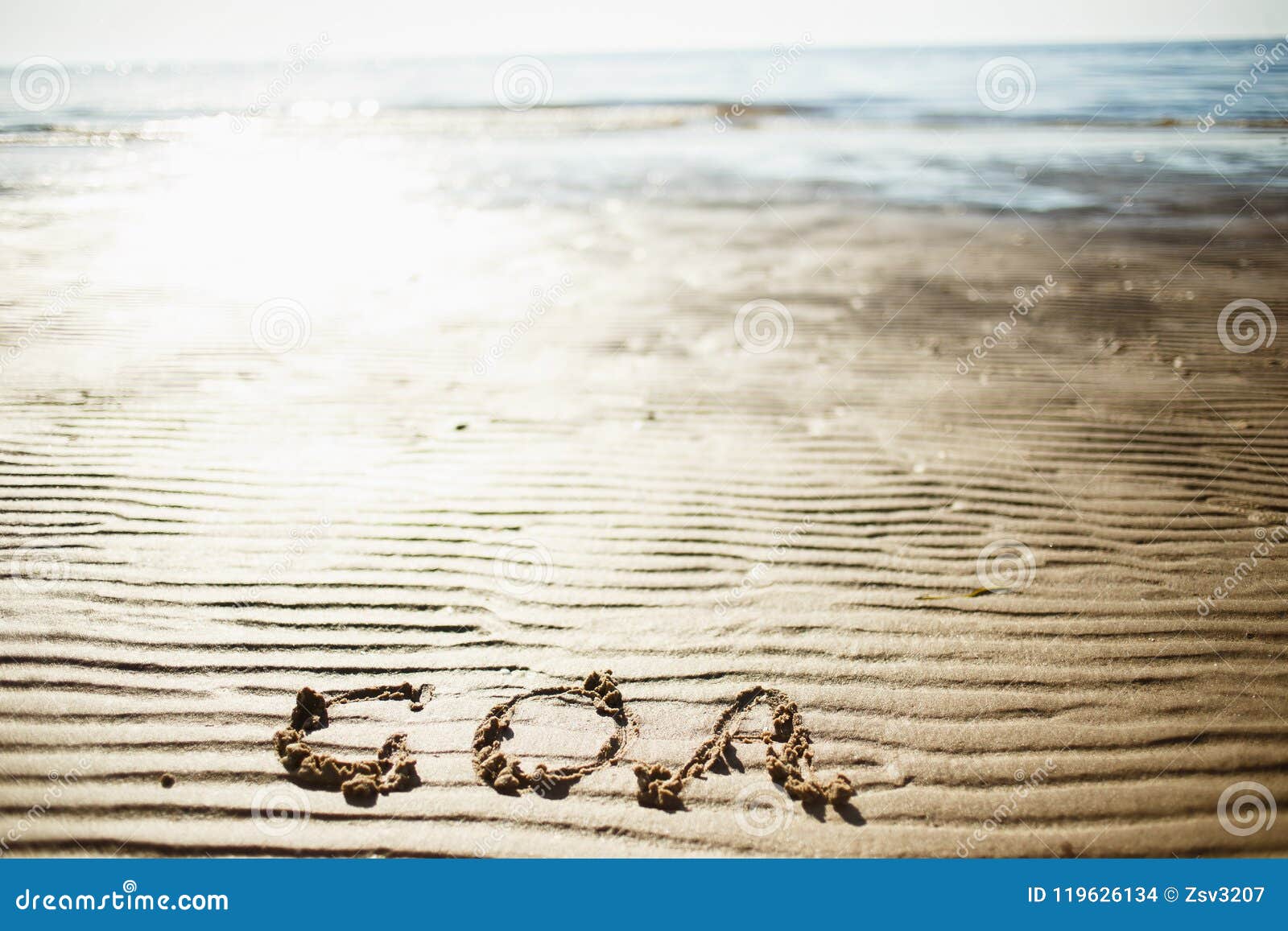 The Word Goa is Written on the Sand by the Sea. Trace on the Beach ...
