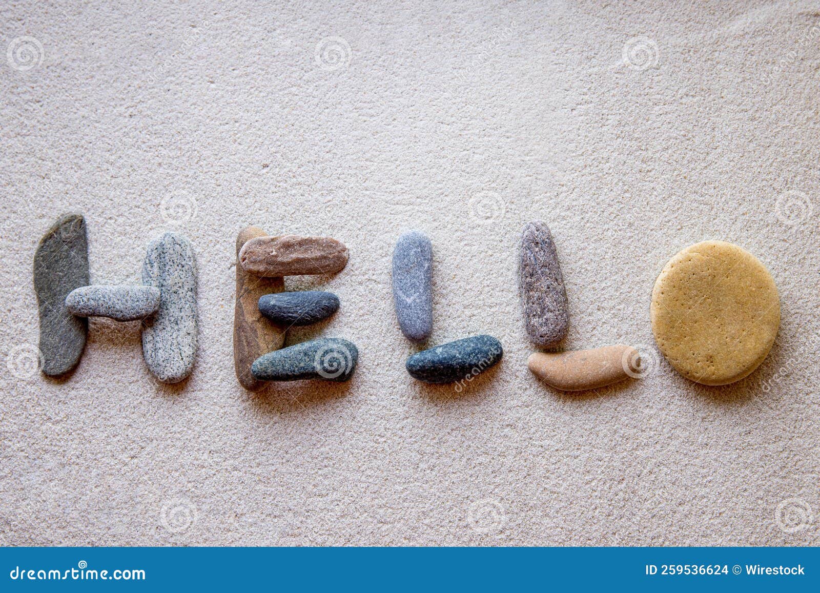 Word "Hello" Written Using Colored Stones on White Sand Stock Photo ...