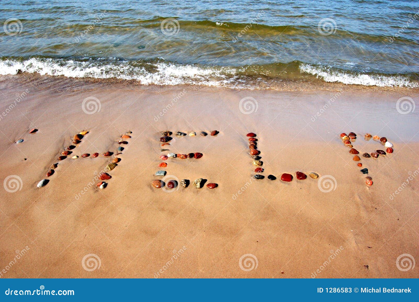 Word HELP on beach sand stock image. Image of inscripion - 1286583