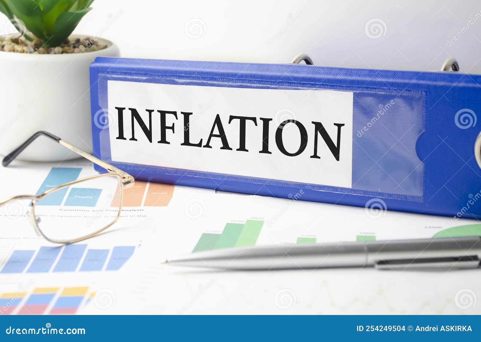 Word Inflation on Blue File Folder and Charts Stock Photo - Image of ...