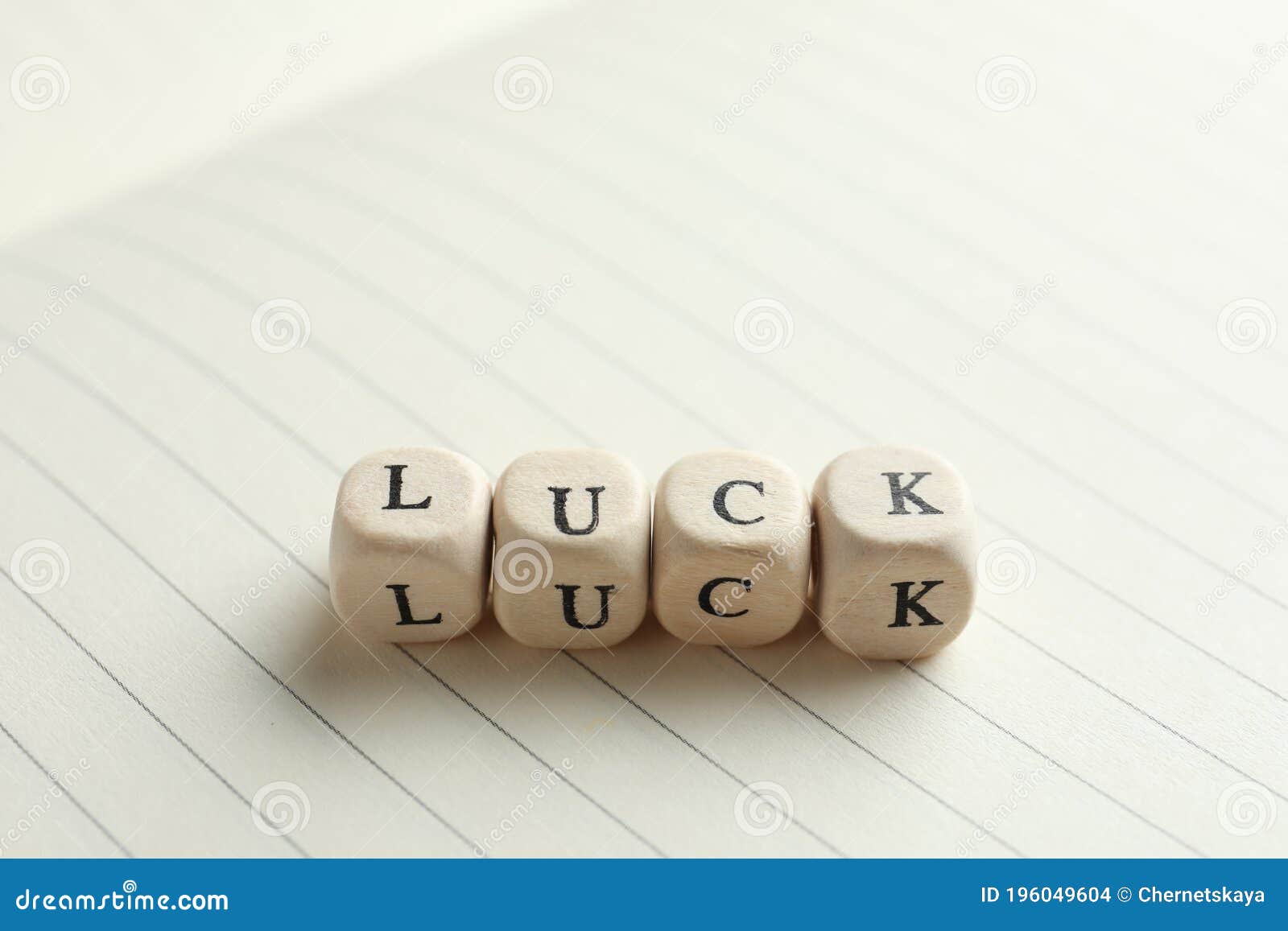 Word LUCK Made with Wooden Cubes on Open Notebook, Closeup Stock Photo ...