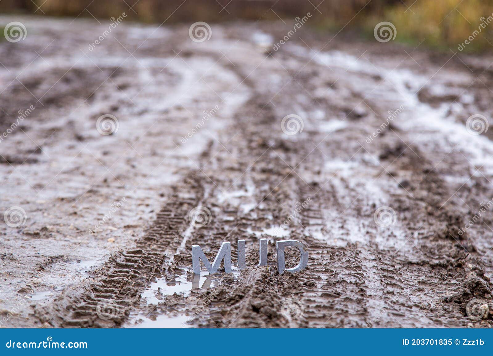 The Word Mud Composed of Silver Metal Letters on Wet Dirt Surface Stock ...