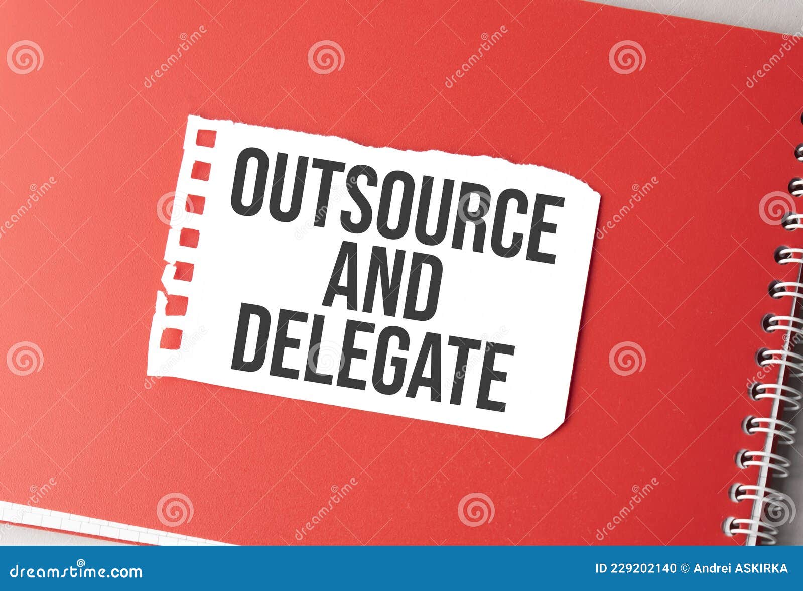 The Word Outsource and Delegate on Torn Paper on Red Notepad Stock ...