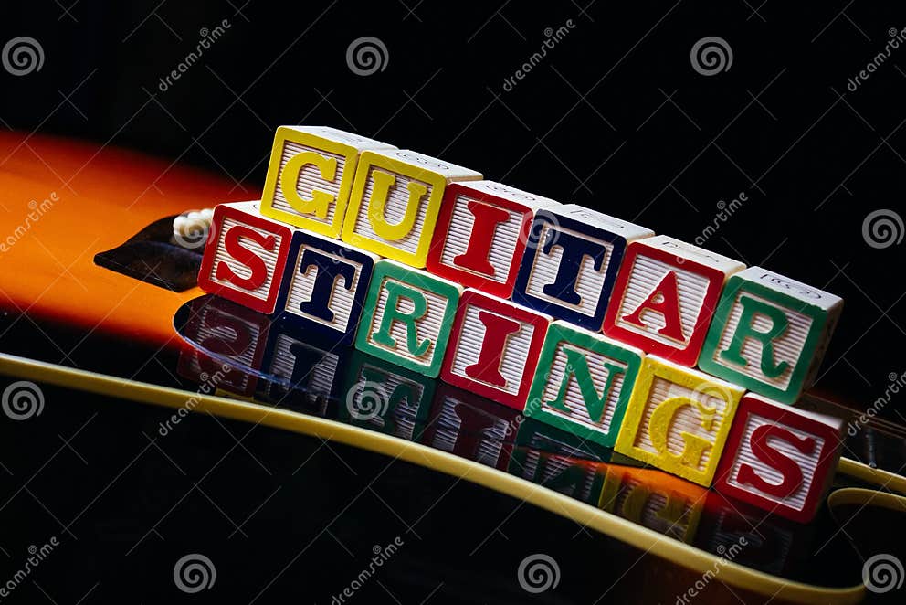 Word or Phrase Guitar Strings Made with Letter Cubes, Standing on ...