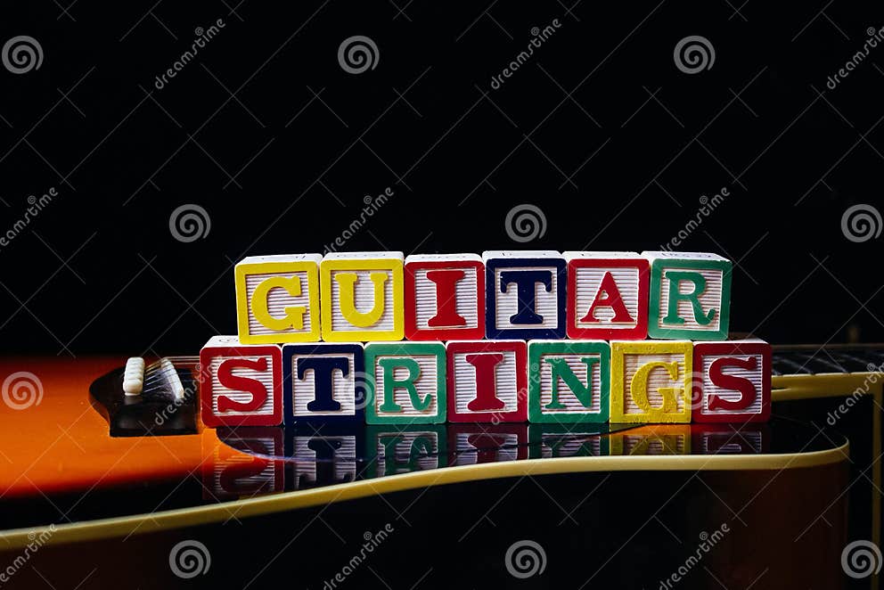 Word or Phrase Guitar Strings Made with Letter Cubes, Standing on ...
