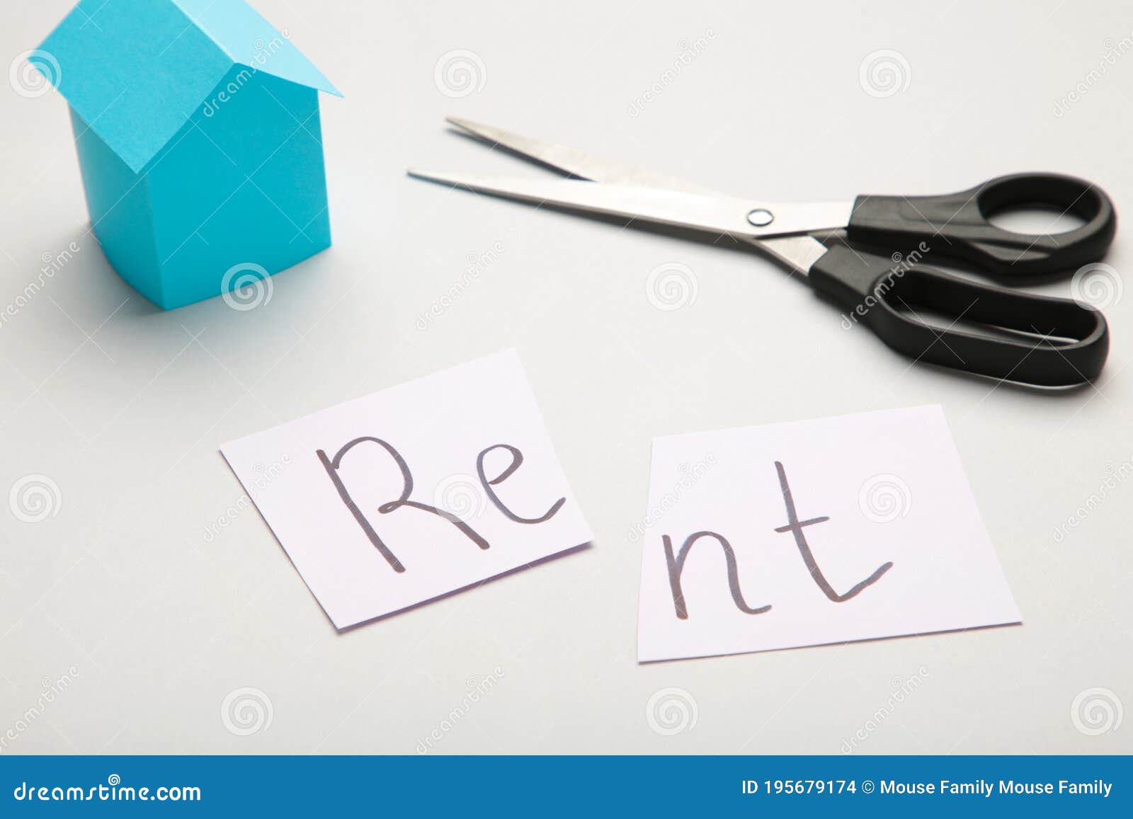 The Word Rent Written on Paper and Cut in Half with a Pair of Scissors ...
