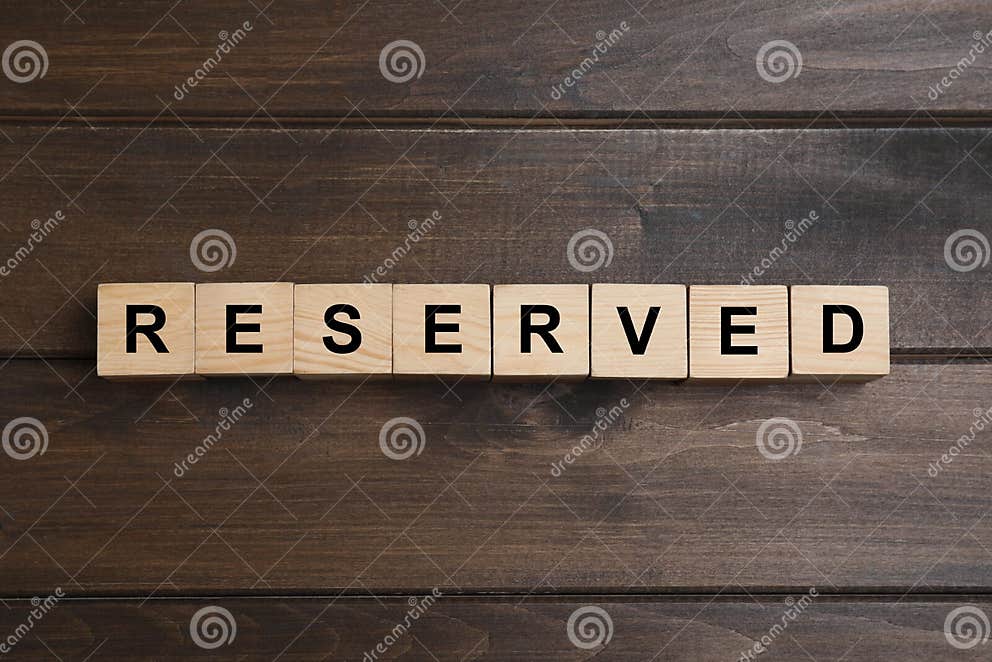 Word RESERVED Made with Cubes on Wooden Surface, Top View. Table ...
