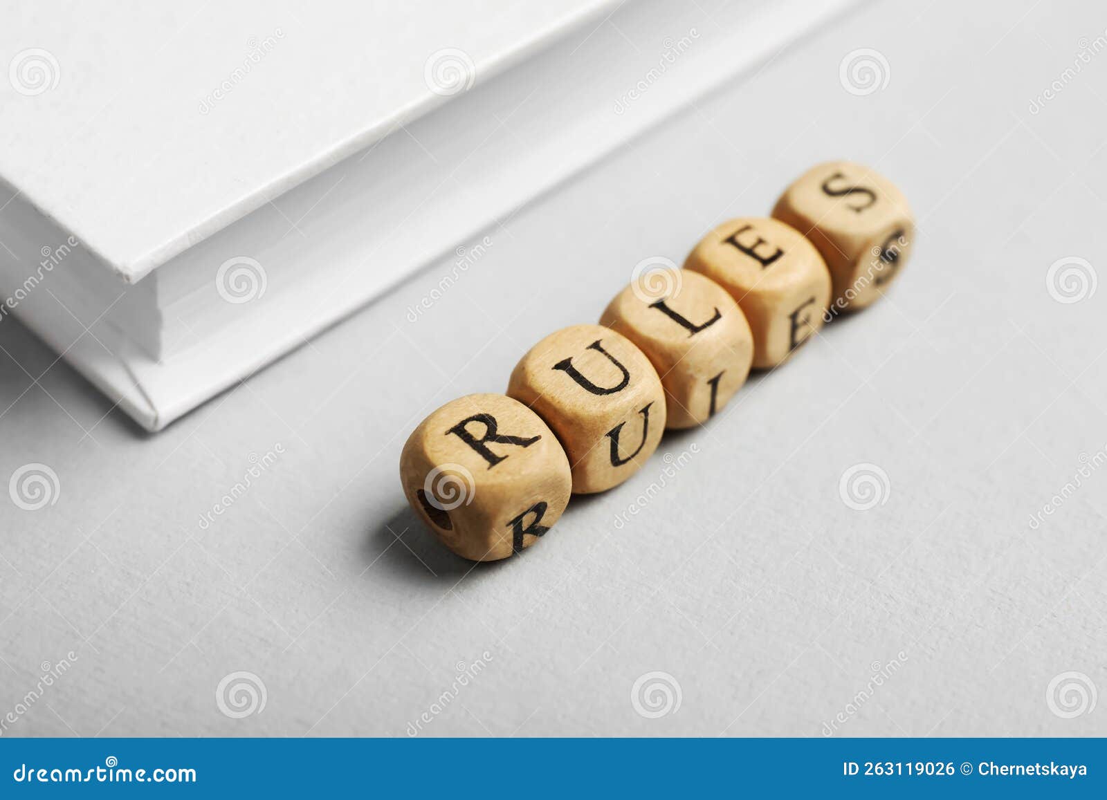 Word Rules Made of Wooden Cubes with Letters and Book on White Table ...