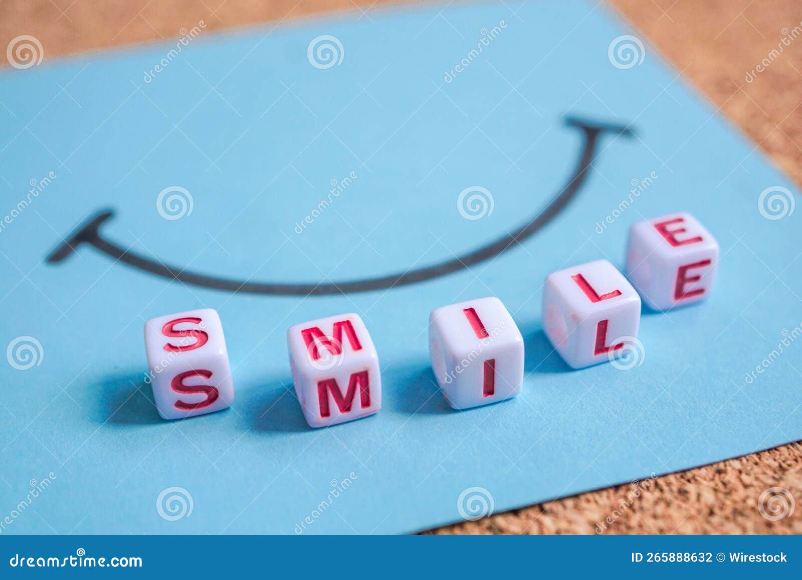 Word Smile with Red Cube Letters in Front of a Smile Icon on a Blue ...