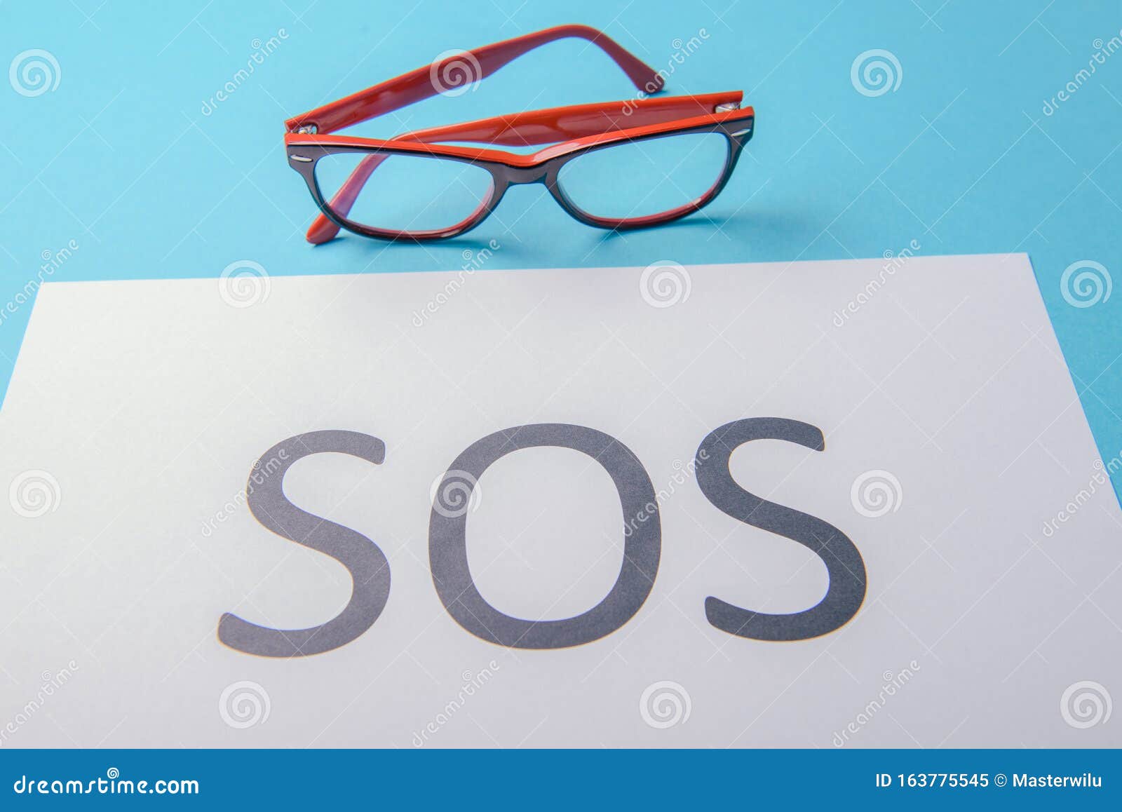 Word SOS written on paper stock image. Image of poster - 163775545