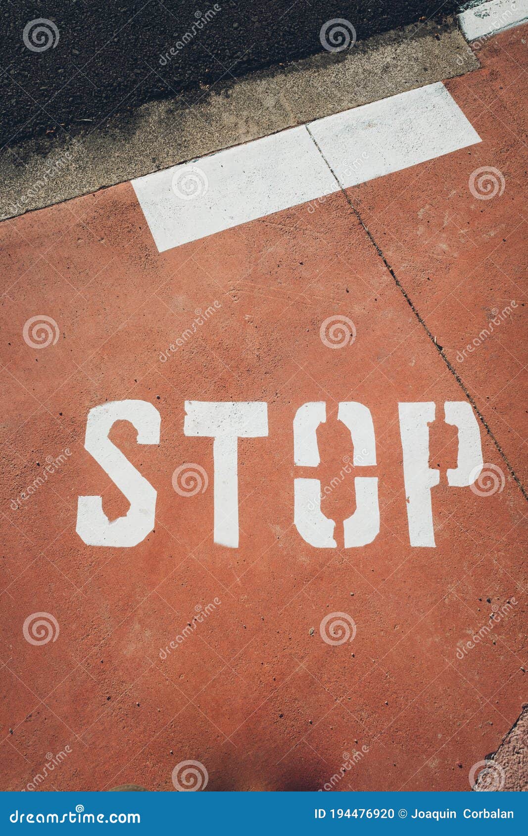 The Word Stop Painted in White Capital Letters on a Red Floor Stock ...