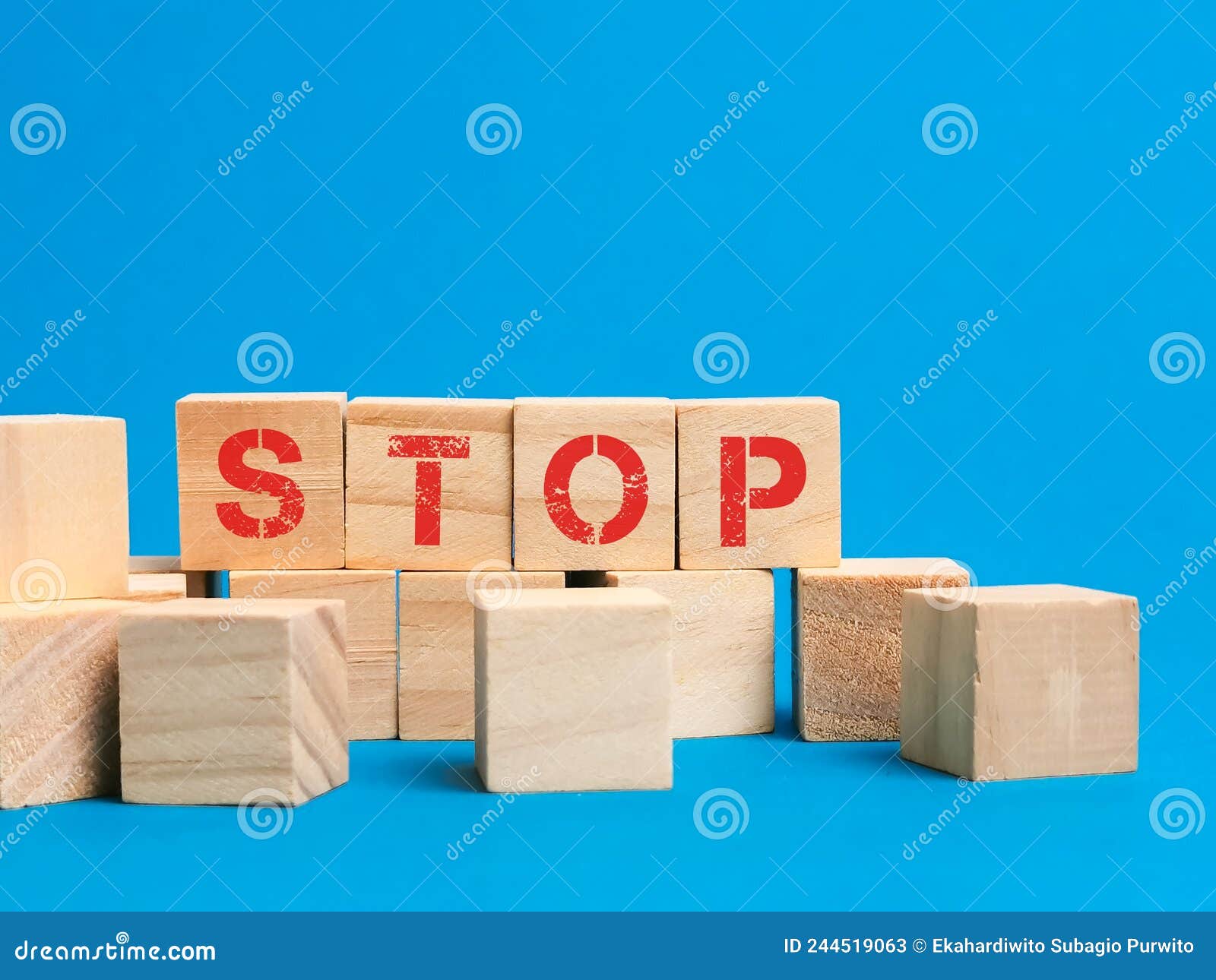 Word Stop on Wooden Cubes Against Blue Background. Stock Image - Image ...