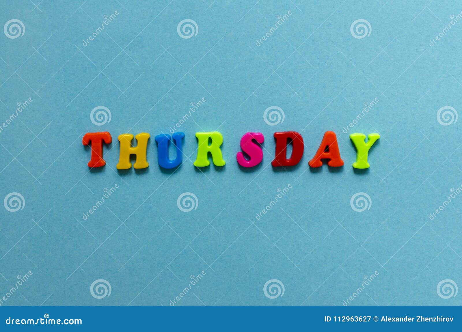 Word `thursday` of Colored Plastic Magnetic Letter on Blue Paper ...