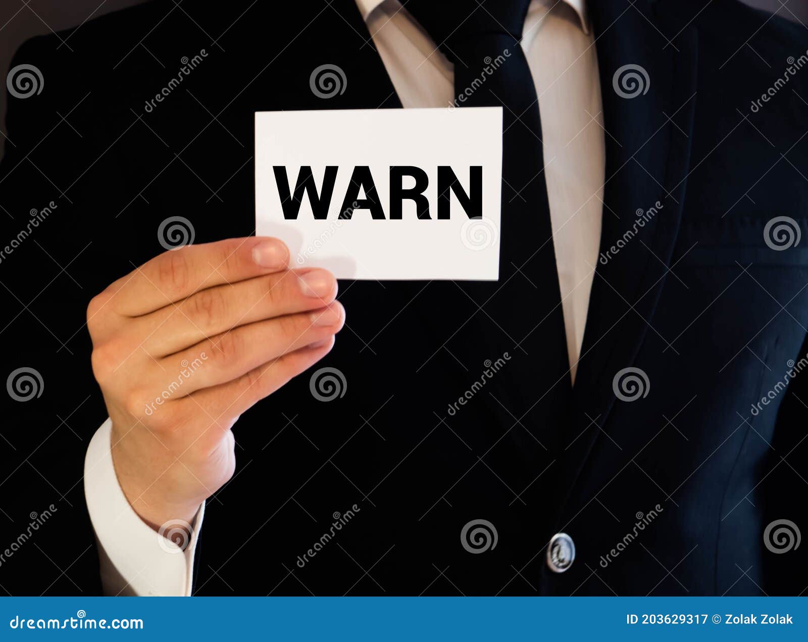 The Word WARN Written on a White Card in the Hands of a Businessman ...
