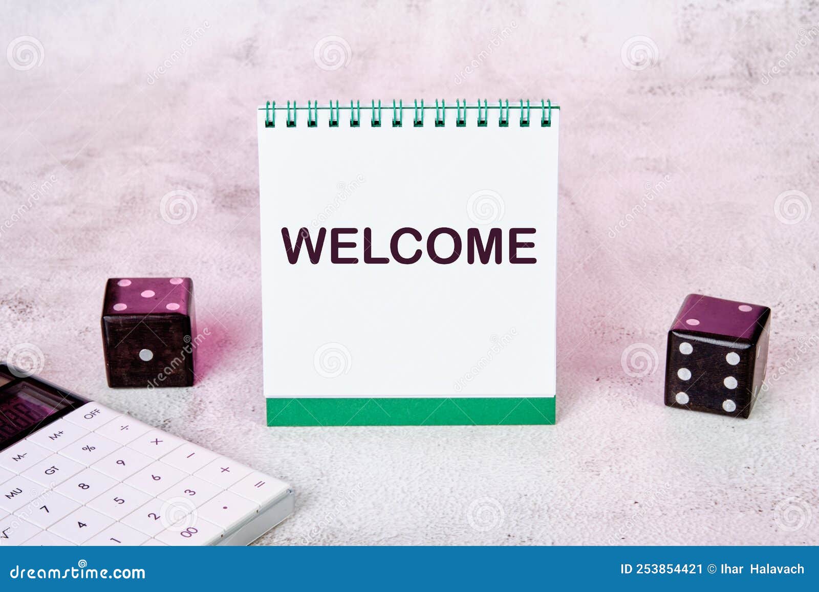 The Word WELCOME is Written on a Notepad, There are Dice and a ...