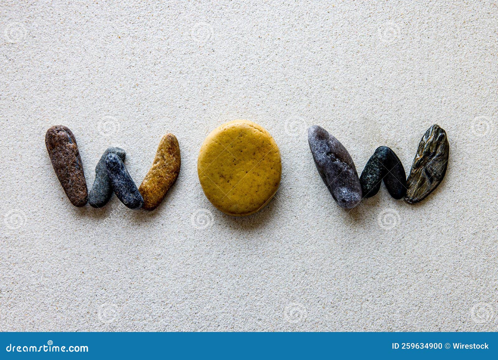 Word WOW is Written Using Colored Stones on a White Grainy Surface ...