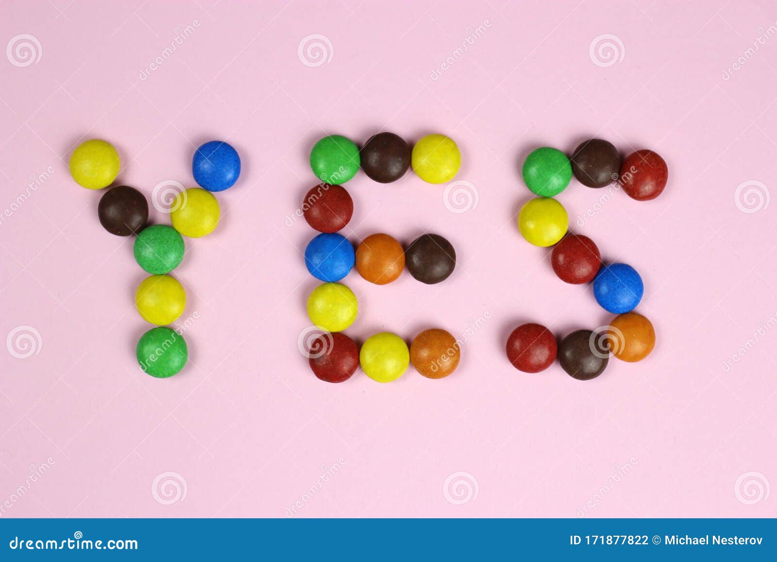 The Word Yes from Colored Candies on a Pink Background Stock Photo ...
