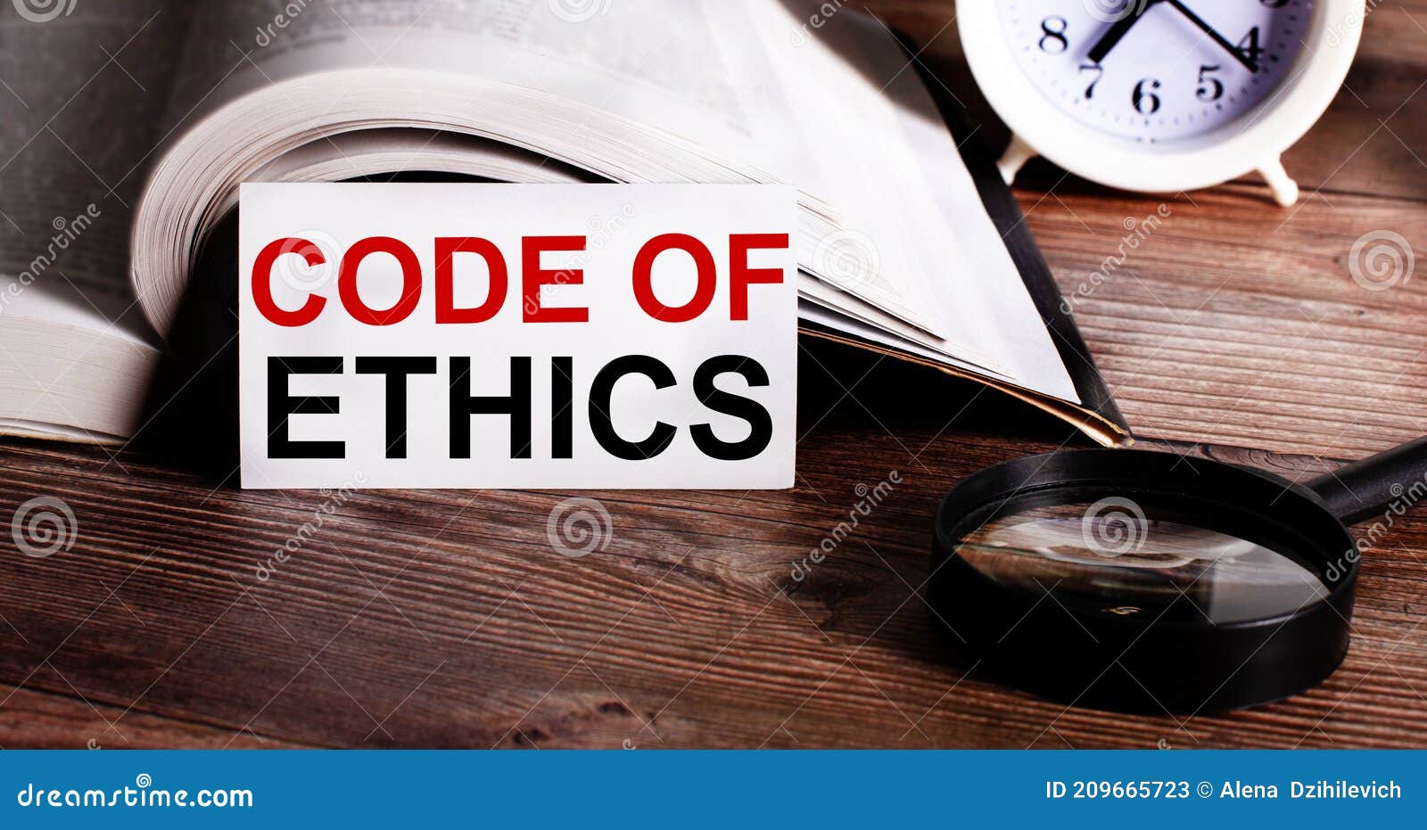 The Words CODE of ETHICS Written on a White Card Near an Open Book ...