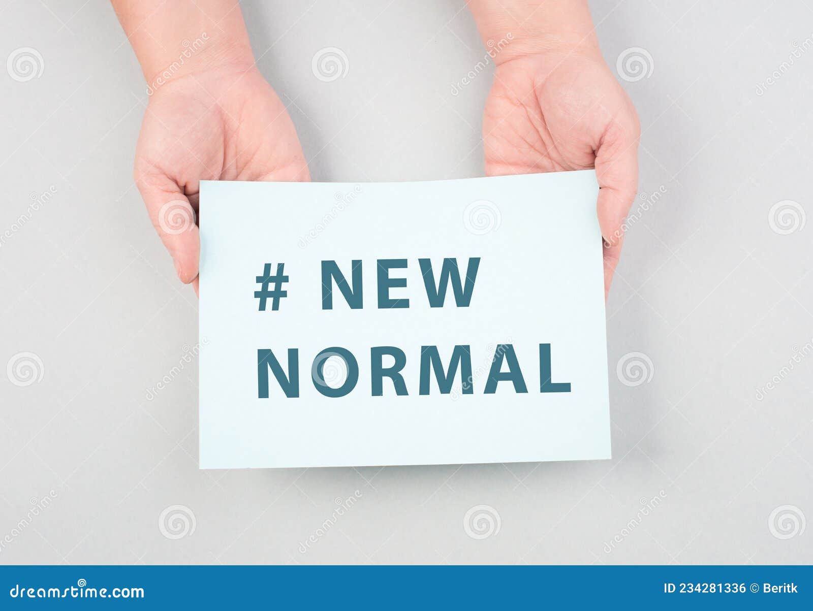 The Words New Normal are Standing on a Paper, Hands Holding the Message ...