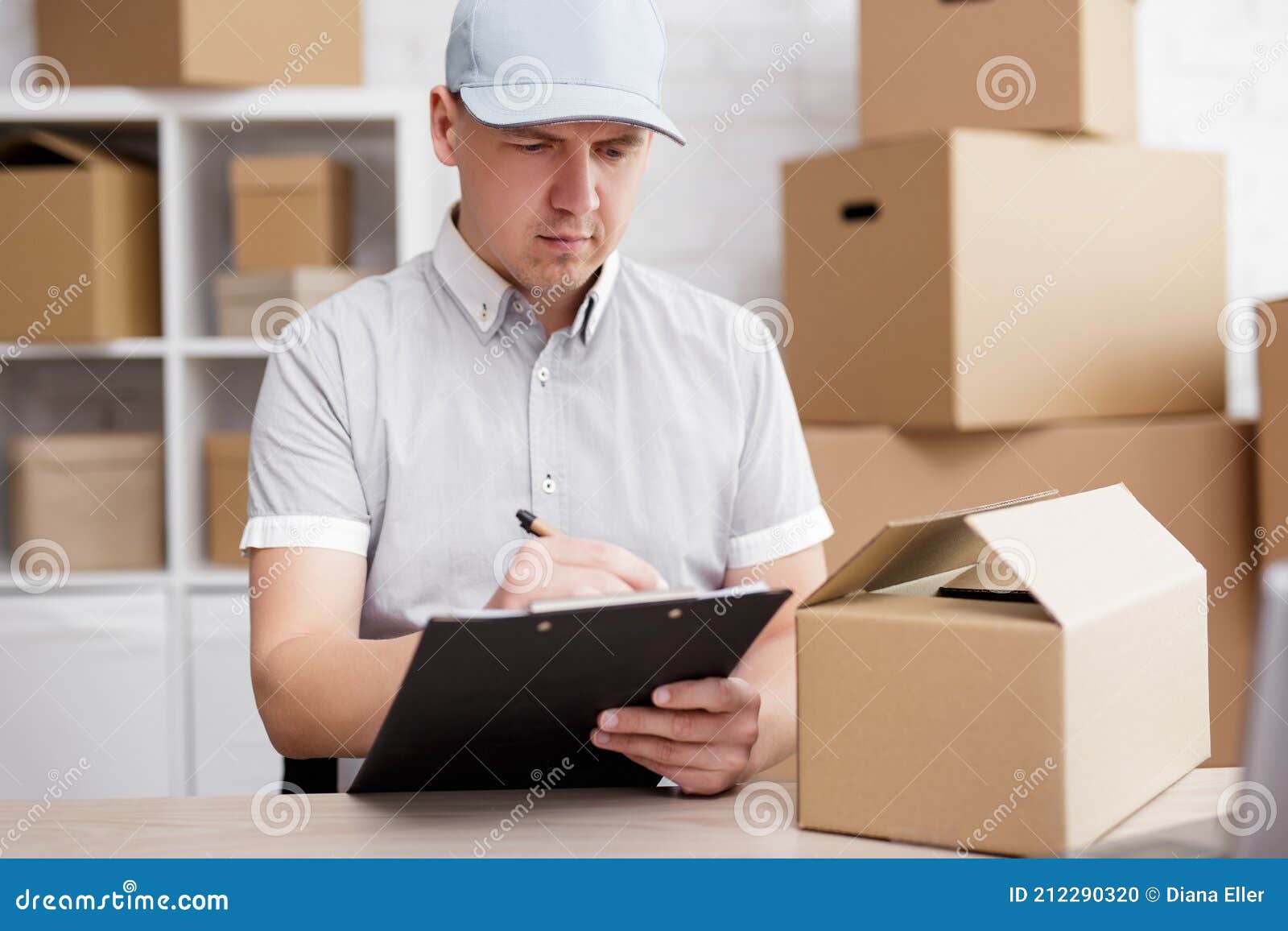 Work, Business and Delivery Concept - Handsome Postman Writing ...