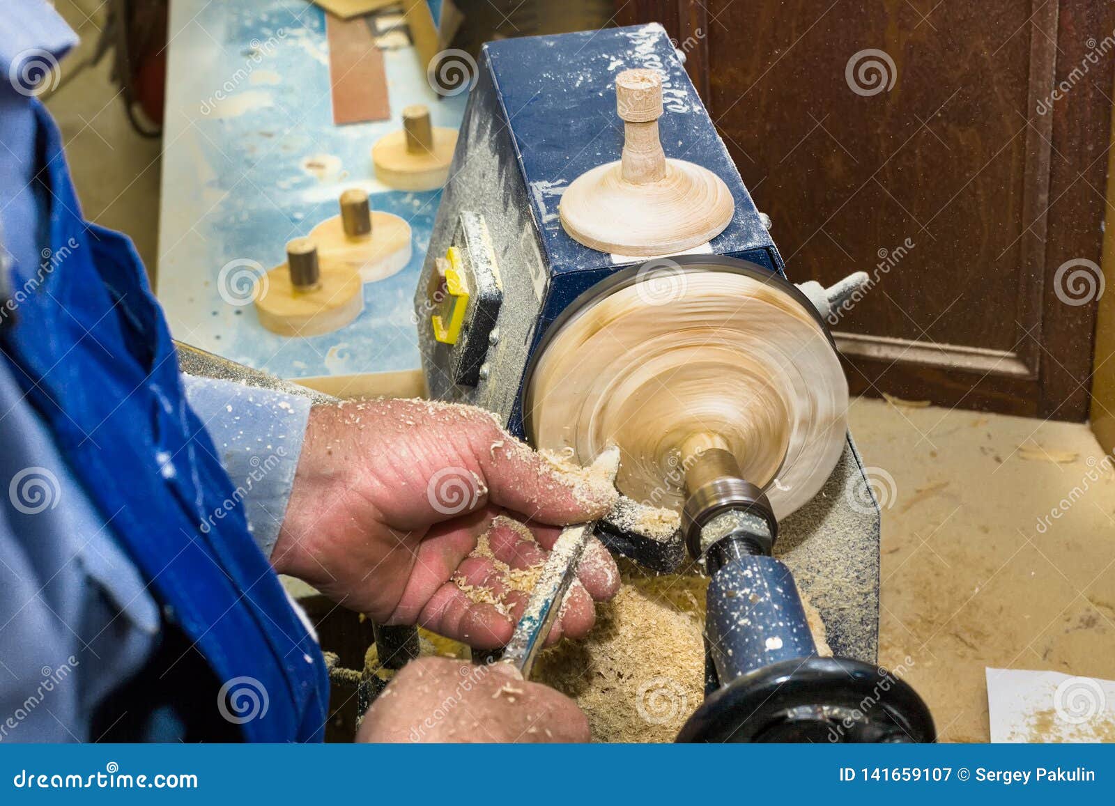 Work Carpenter on a Lathe on a Tree. Close-up of a Man`s Hands with a ...