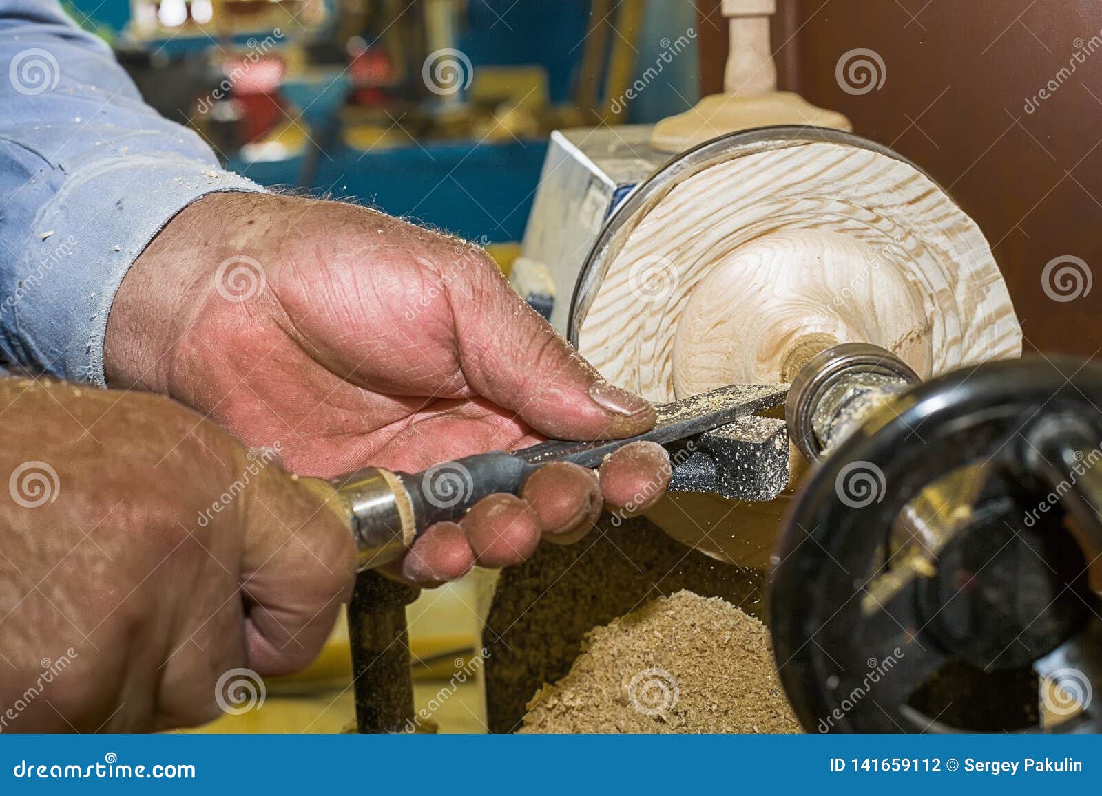 Work Carpenter on a Lathe on a Tree. Close-up of a Man`s Hands with a ...