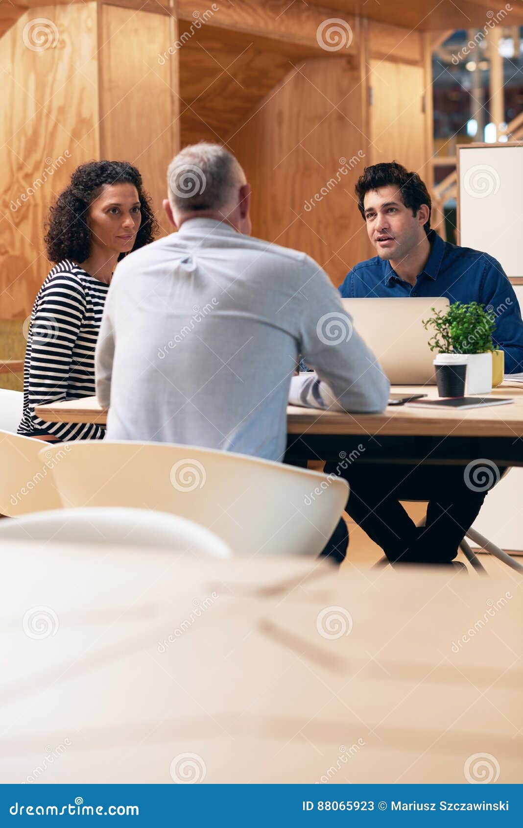 Work Colleagues Discussing Business Together in an Office Stock Image ...