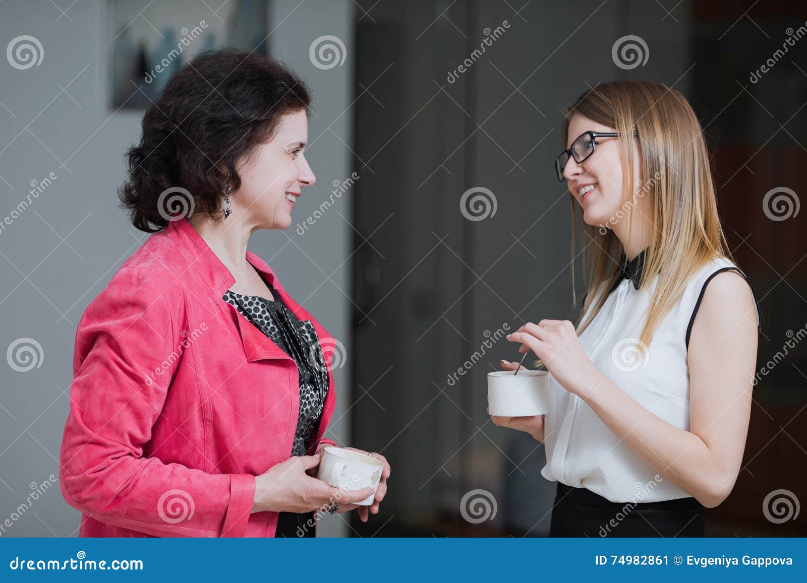 Work Colleagues in the Office Talking To Each Other during the Break ...
