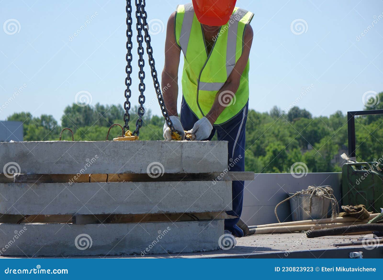 Work at a Construction Site. Unloading-loading Concrete Rings Stock ...