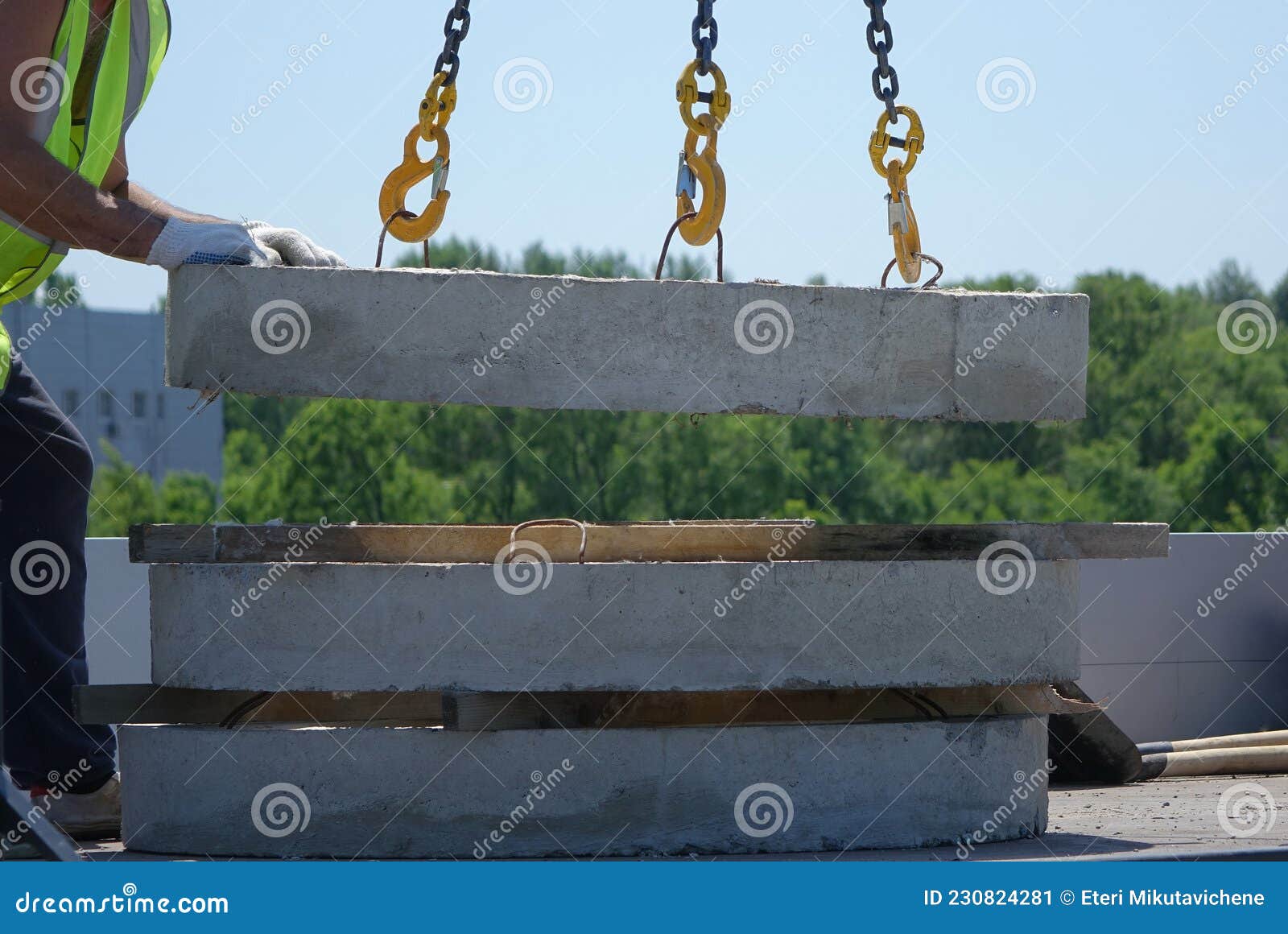 Work at a Construction Site. Unloading-loading Concrete Rings Stock ...