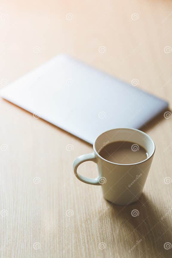 Work Desk with a Laptop Computer, a Cup of Coffee, with Morning ...