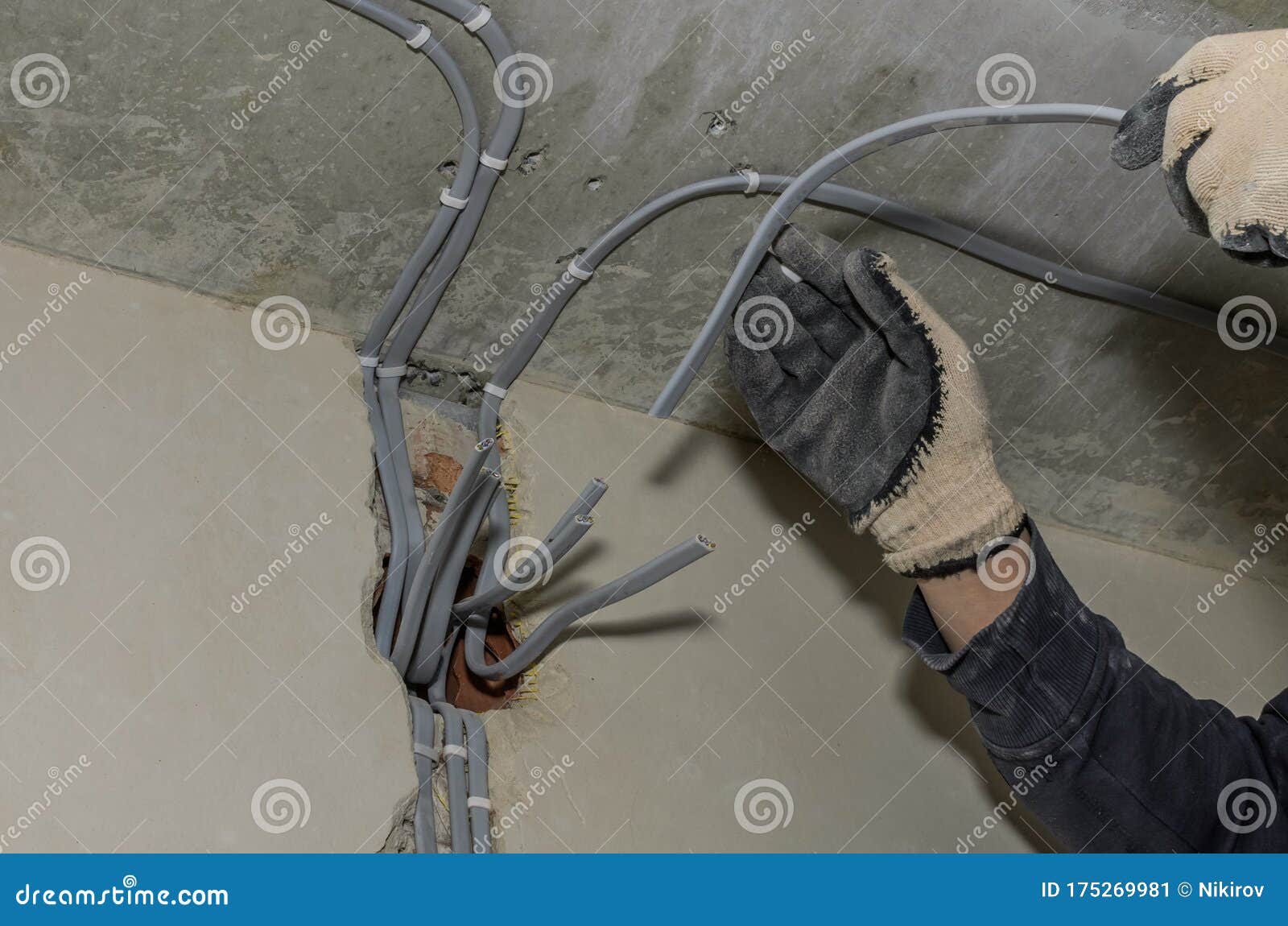 Work Electrician Installs New Wiring in the Wall Stock Image - Image of ...
