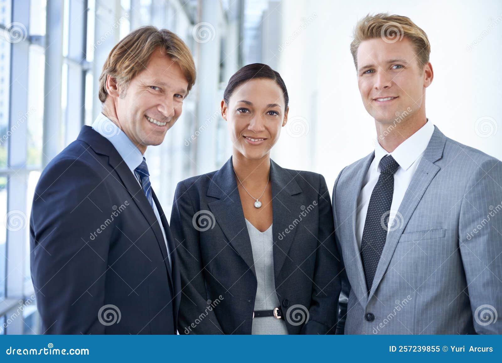 Work Ethic and Drive. Three Smiling Businesspeople Standing Together ...