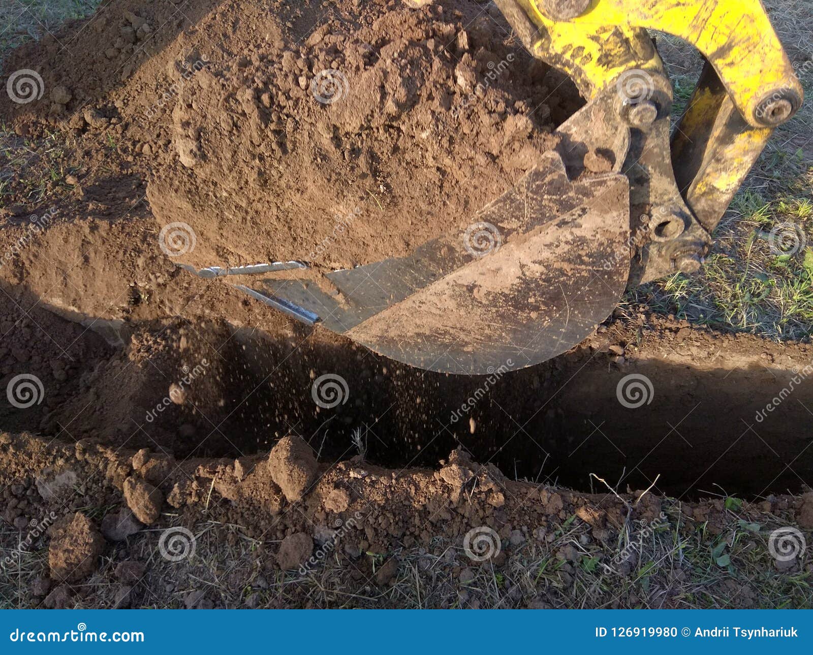 A Work Excavator Digging a Trench for the Foundation of a Building ...