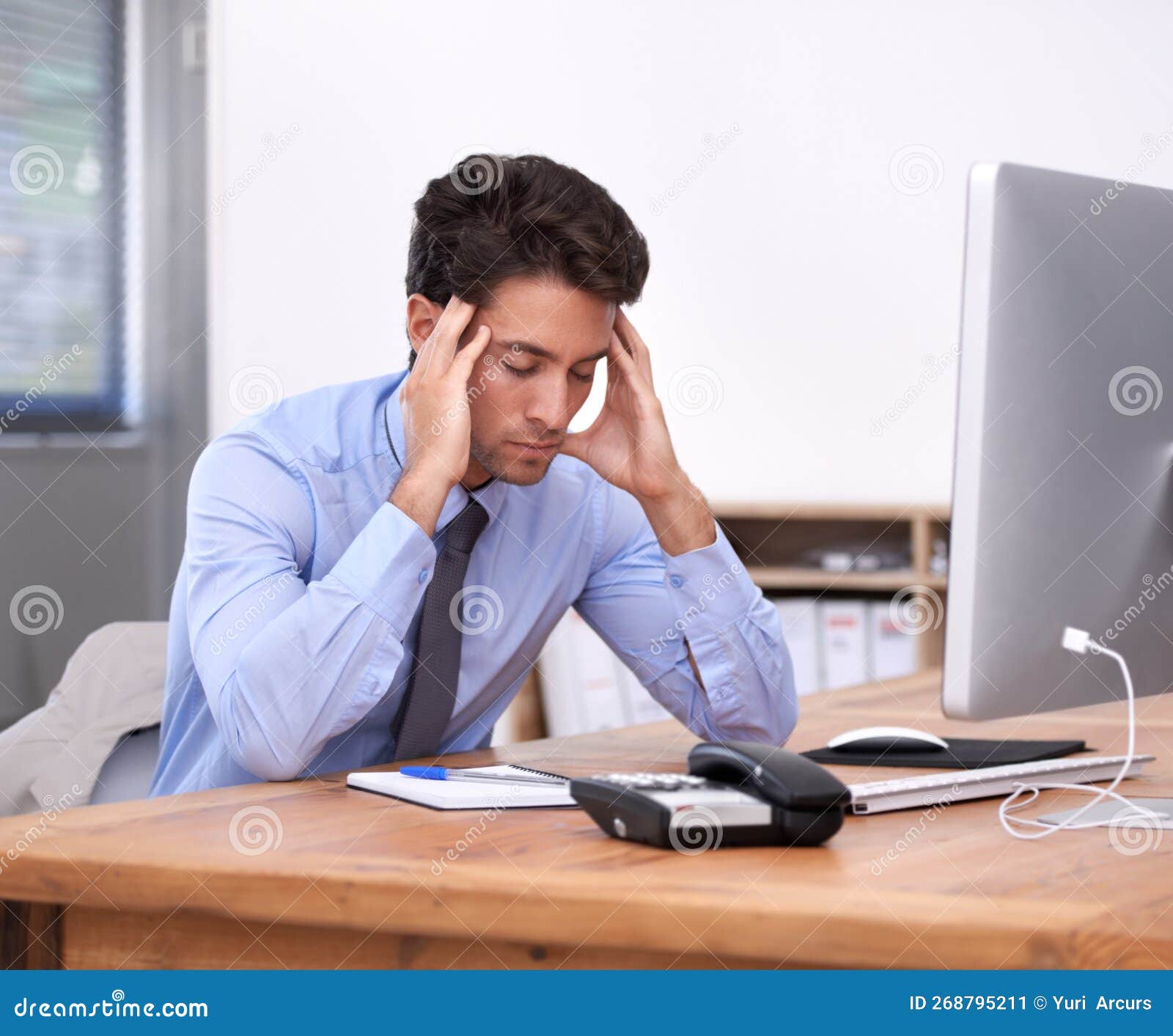 Work is Getting To Him. a Young Businessman Sitting with His Head in ...