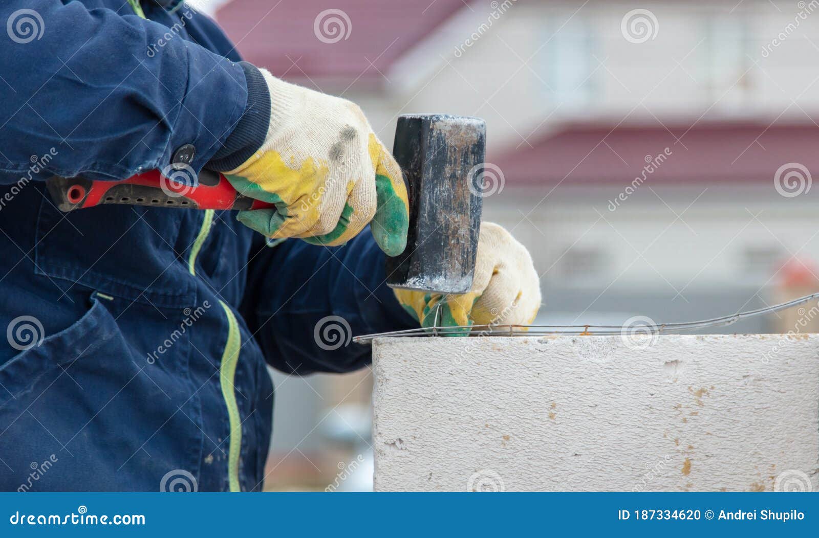 Work Hammer Hammers a Metal Mesh between the Bricks in the Wall Stock ...