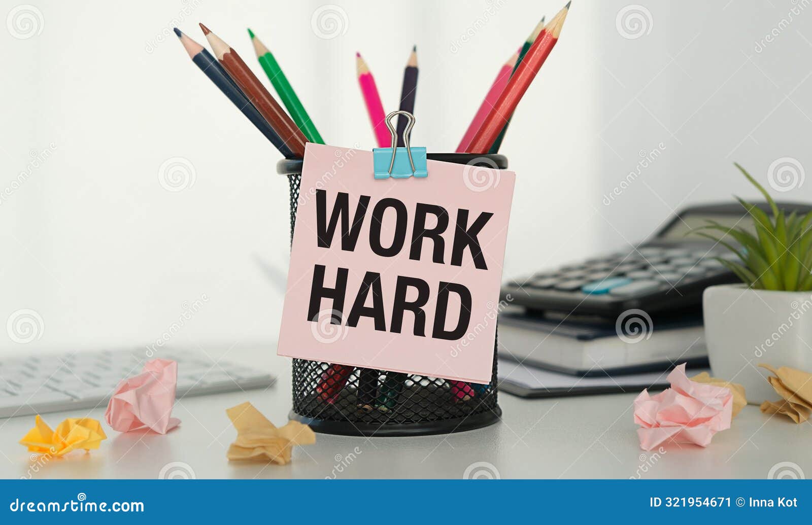 WORK HARD Text on Yellow Sticky Note and Desk with Notepad and ...
