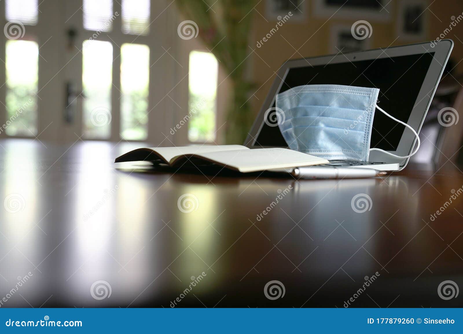 Work at Home during Coronavirus Pandemic. Focus on Face Mask with ...