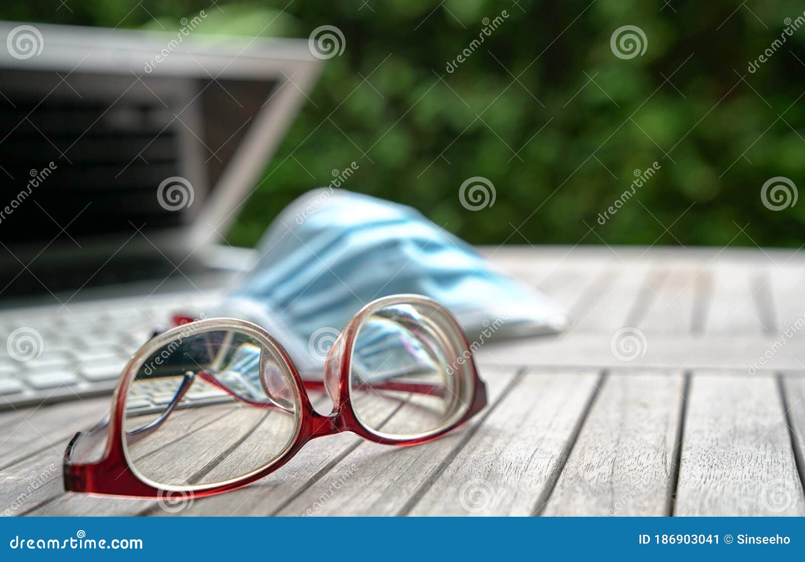 Work at Home. Medical Face Mask on Top of Computer Laptop with ...