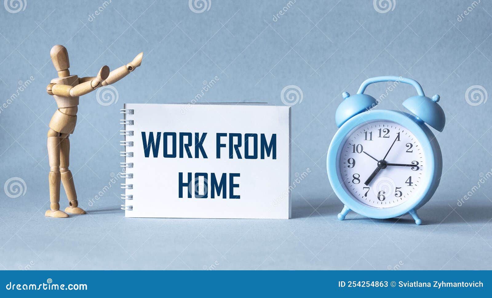 Work from Home Message on Notepad and Blue Background. Wooden Doll and ...