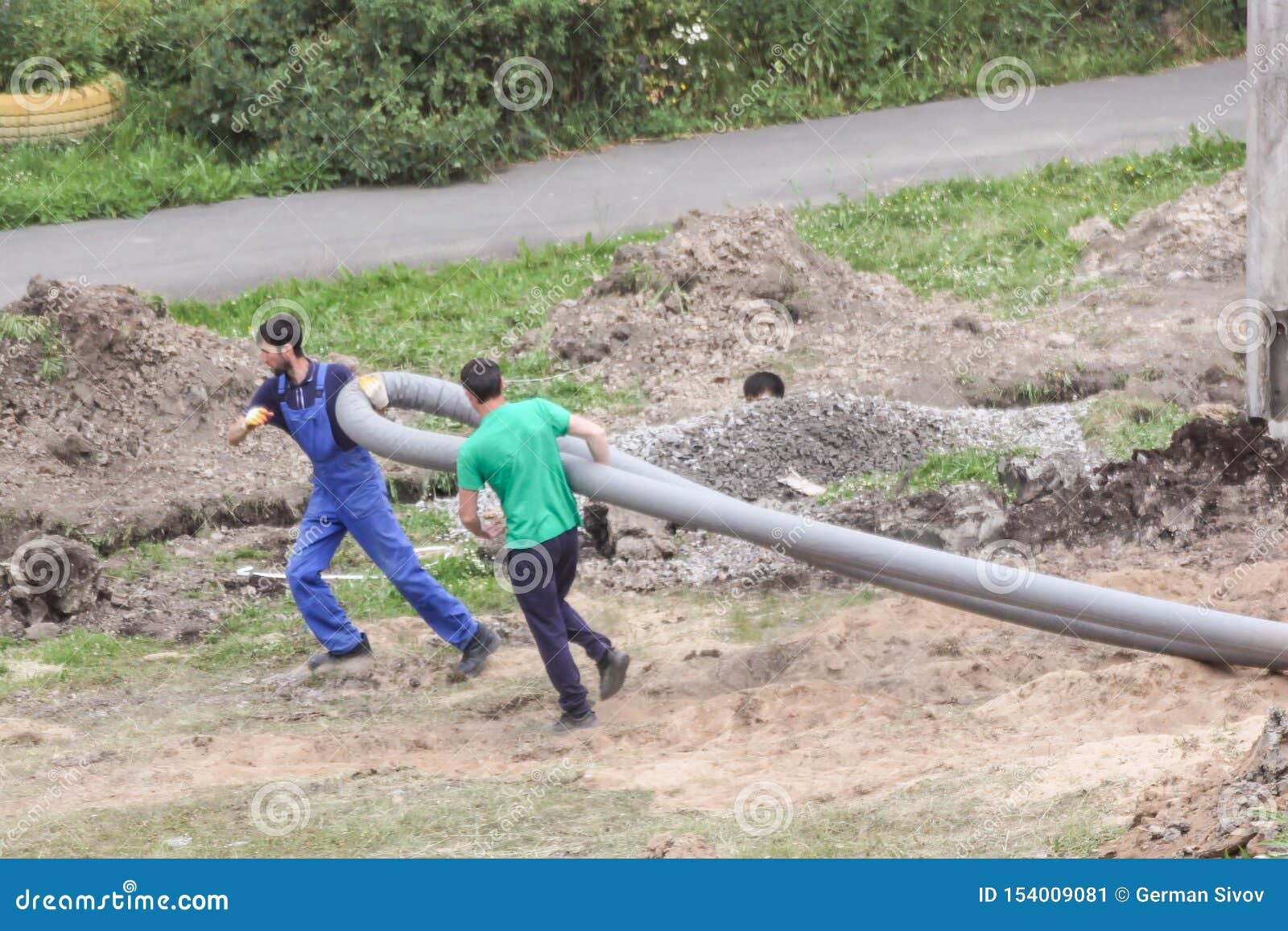 Workers Drag Pipe To the Trench Editorial Photo - Image of yard, dirt ...