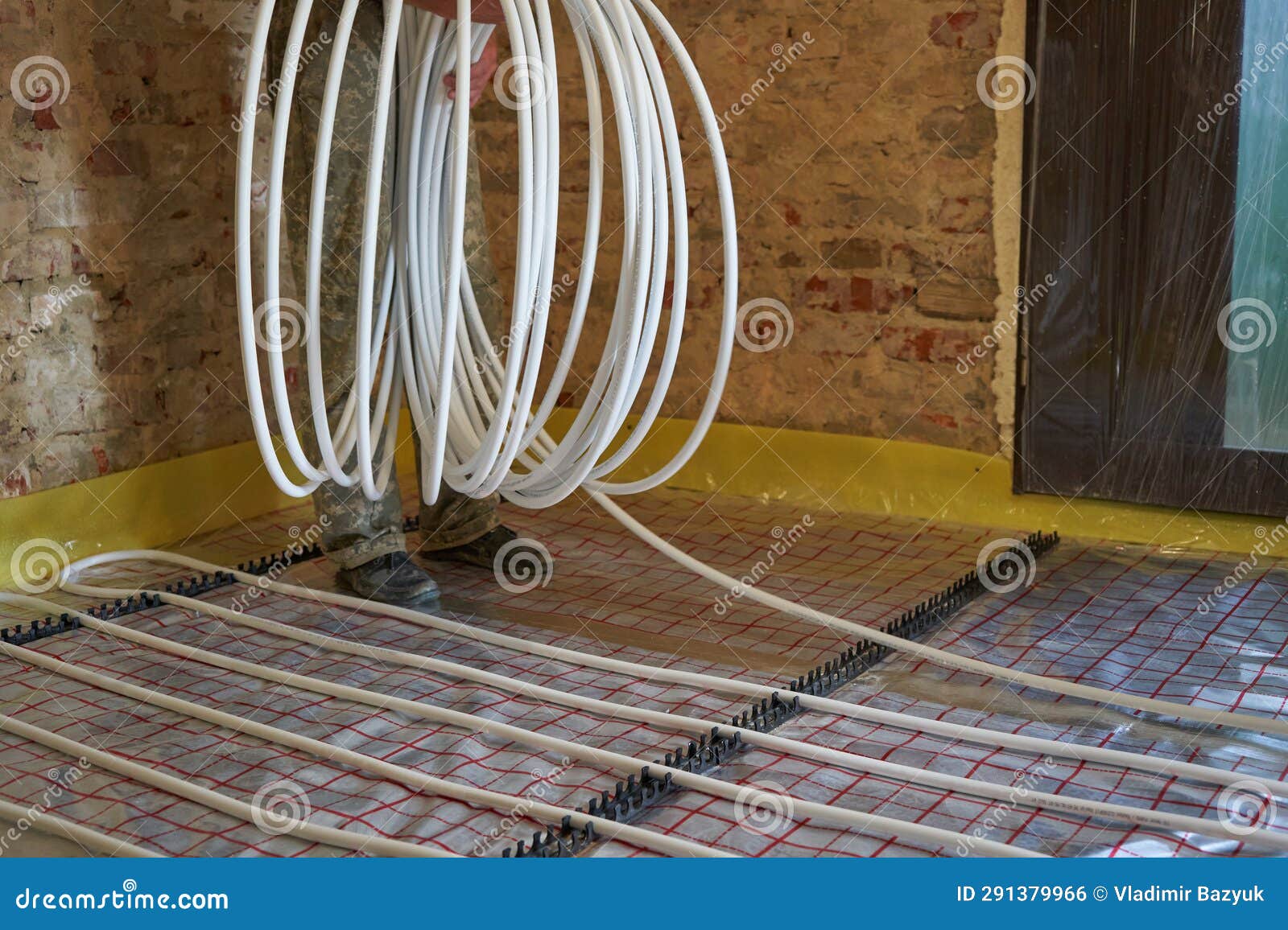 Man Mounted Pipes for Underfloor Heating,work on Installation of the ...