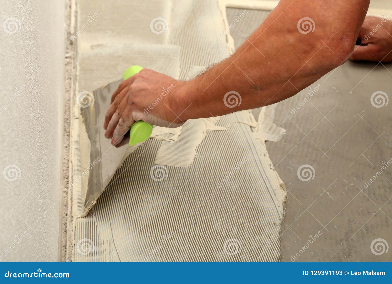 Work on Laying Flooring. Worker Installing New Vinyl Tile Floor. Stock ...